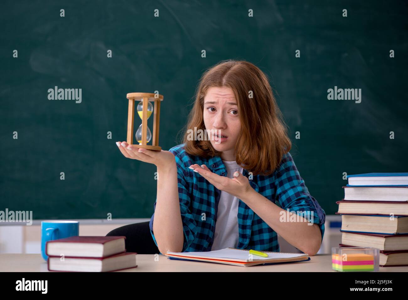 Young girl student in time management concept Stock Photo - Alamy