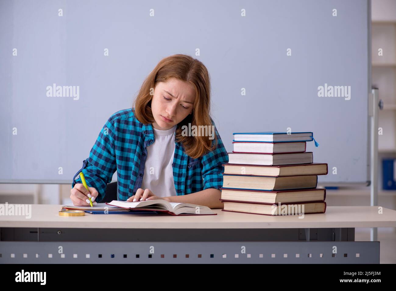 Young girl student preparing for exams in the classroom Stock Photo - Alamy