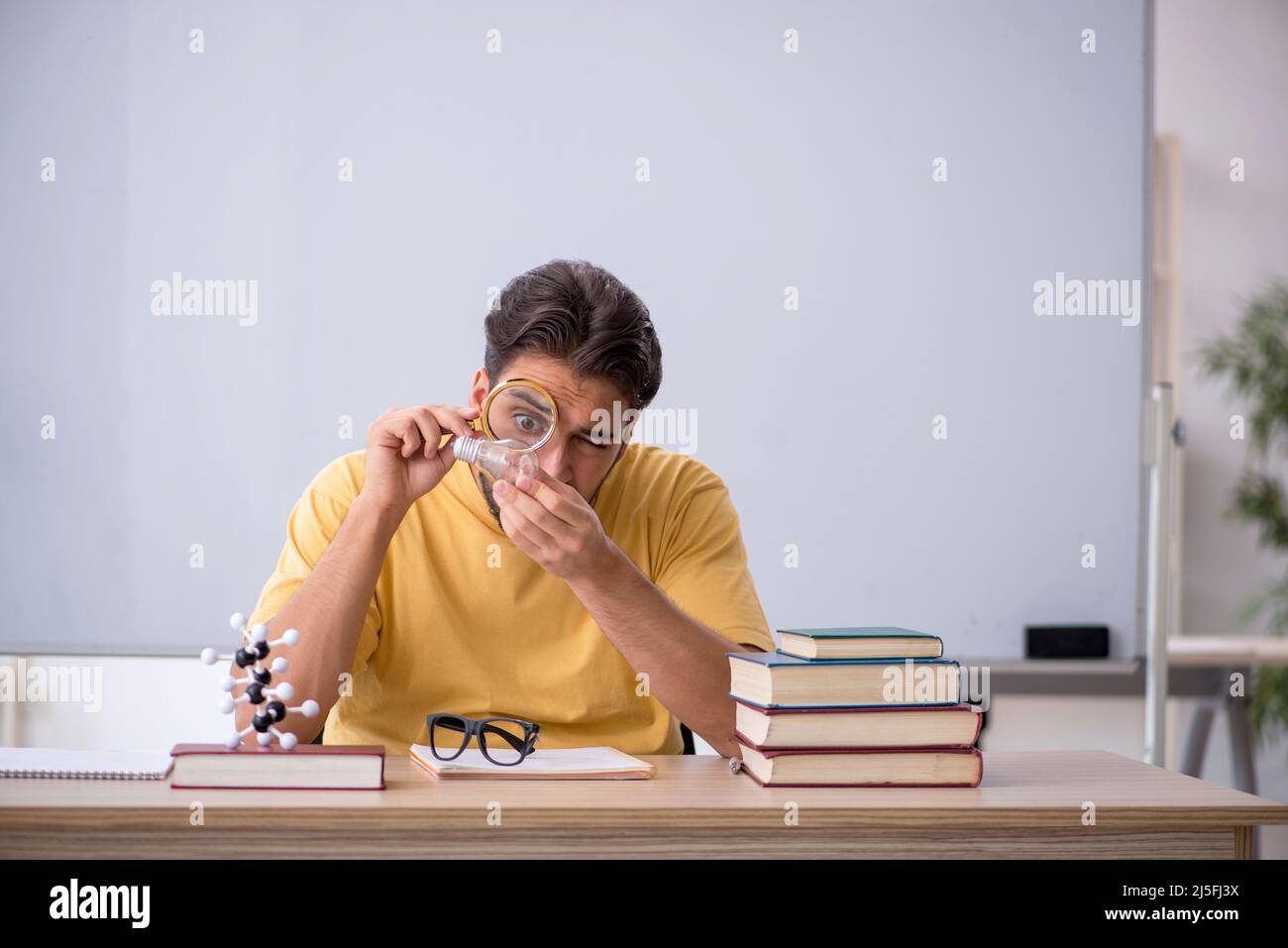Young student in happy idea concept in the classroom Stock Photo - Alamy