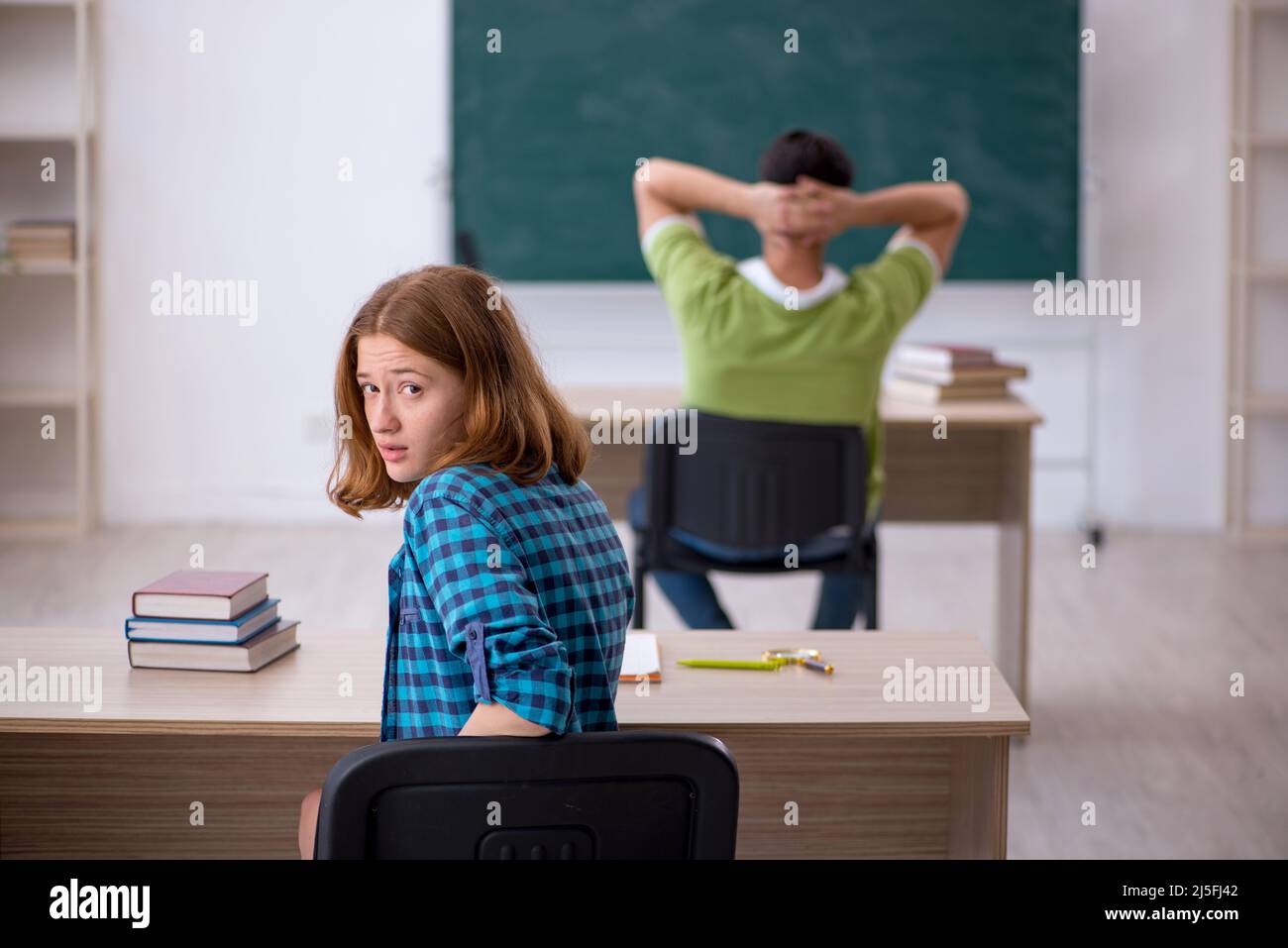 Two students sitting in the class Stock Photo - Alamy