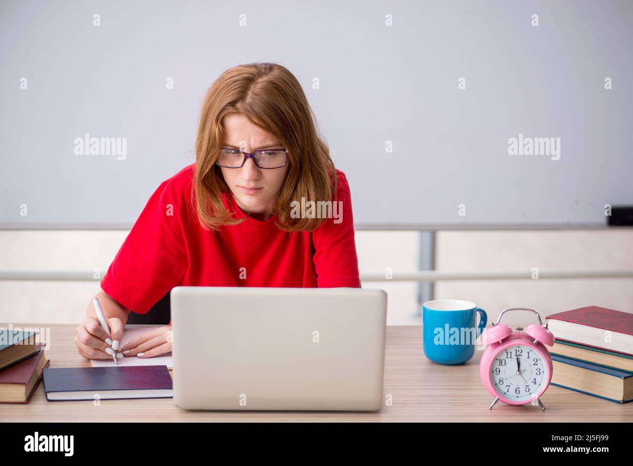Female student preparing for exams in the classroom Stock Photo - Alamy