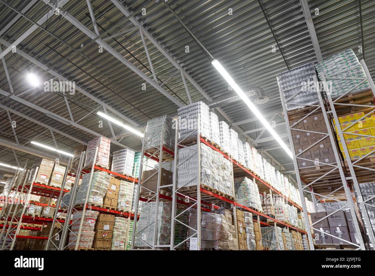 high-bay shelving In a huge warehouse of a logistics center Stock Photo ...