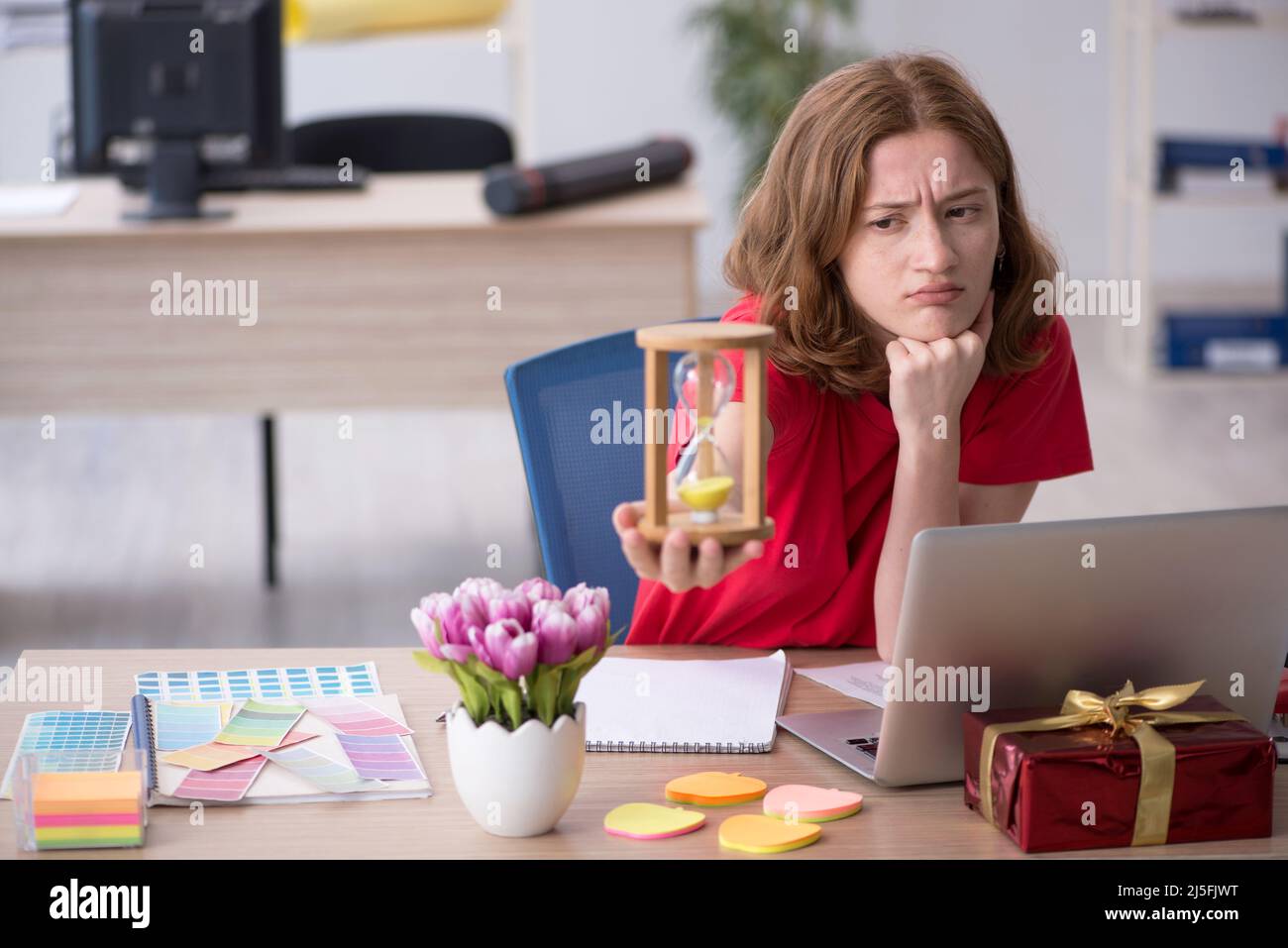 Female designer in time management concept Stock Photo - Alamy