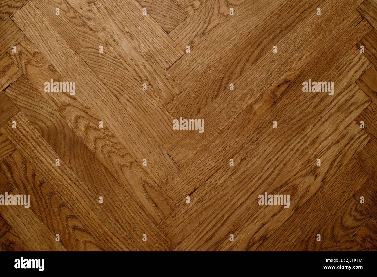 Classic wooden oak parquet in the form of a dark brown Christmas tree ...