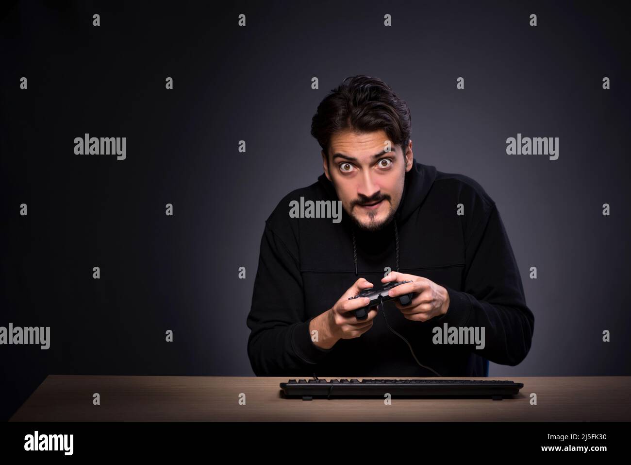 Young gamer on grey background Stock Photo - Alamy