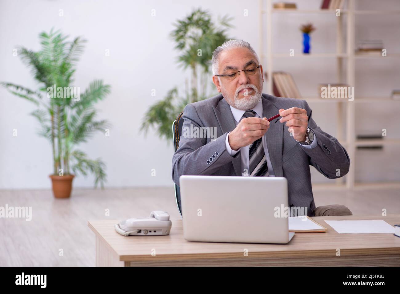 Old businessman employee and too much work at workplace Stock Photo - Alamy