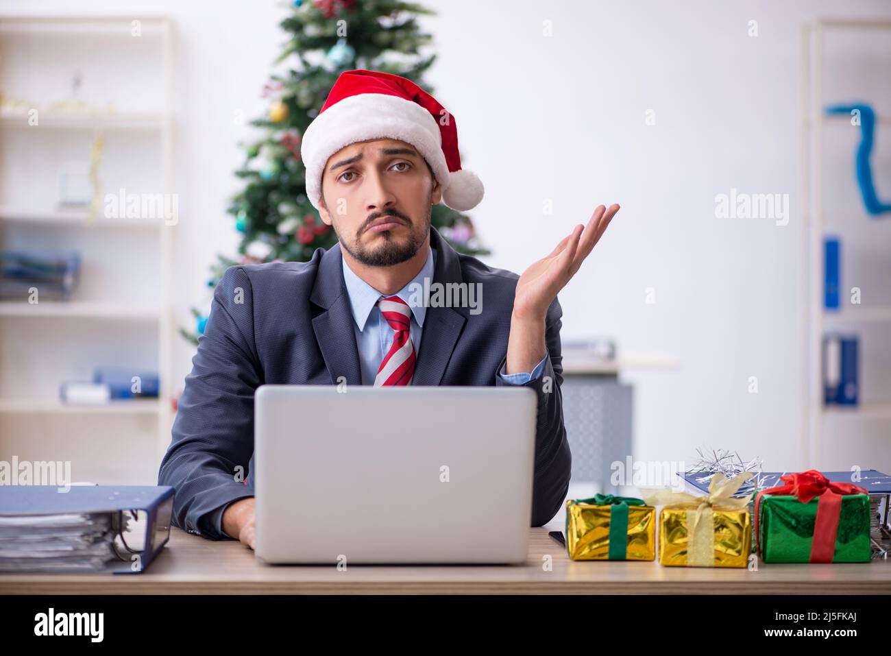 Young employee celebrating Christmas in the office Stock Photo - Alamy
