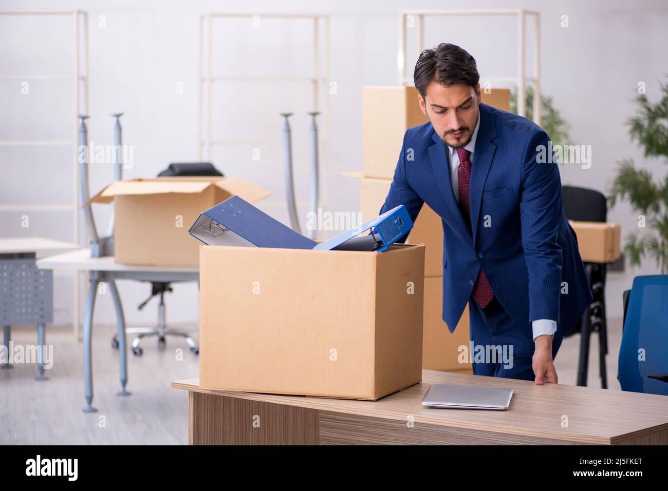 Young employee in relocation concept Stock Photo - Alamy