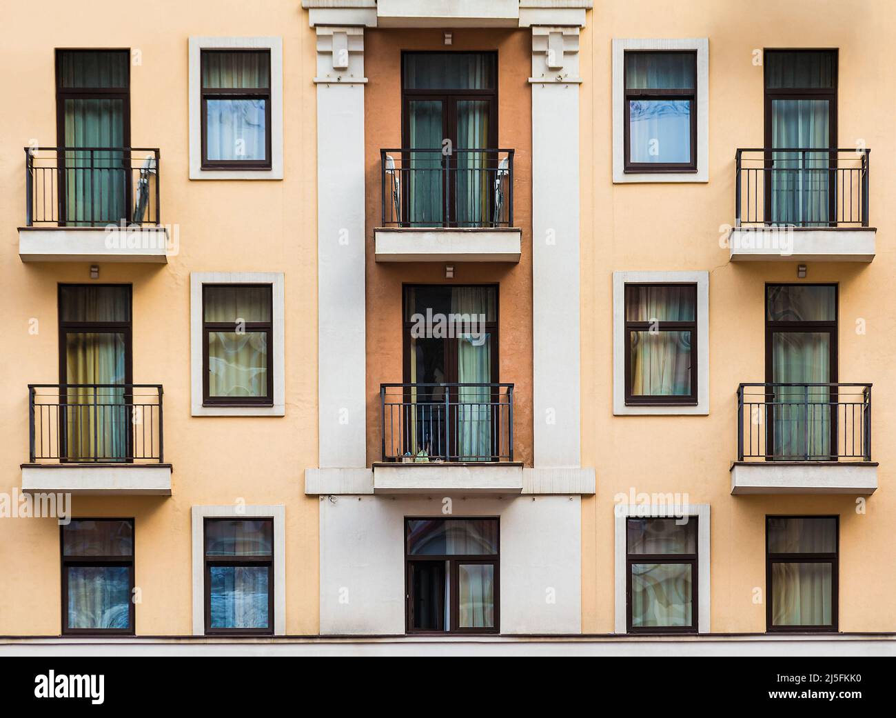 Many balconies and windows in a row on the facade of the modern urban ...