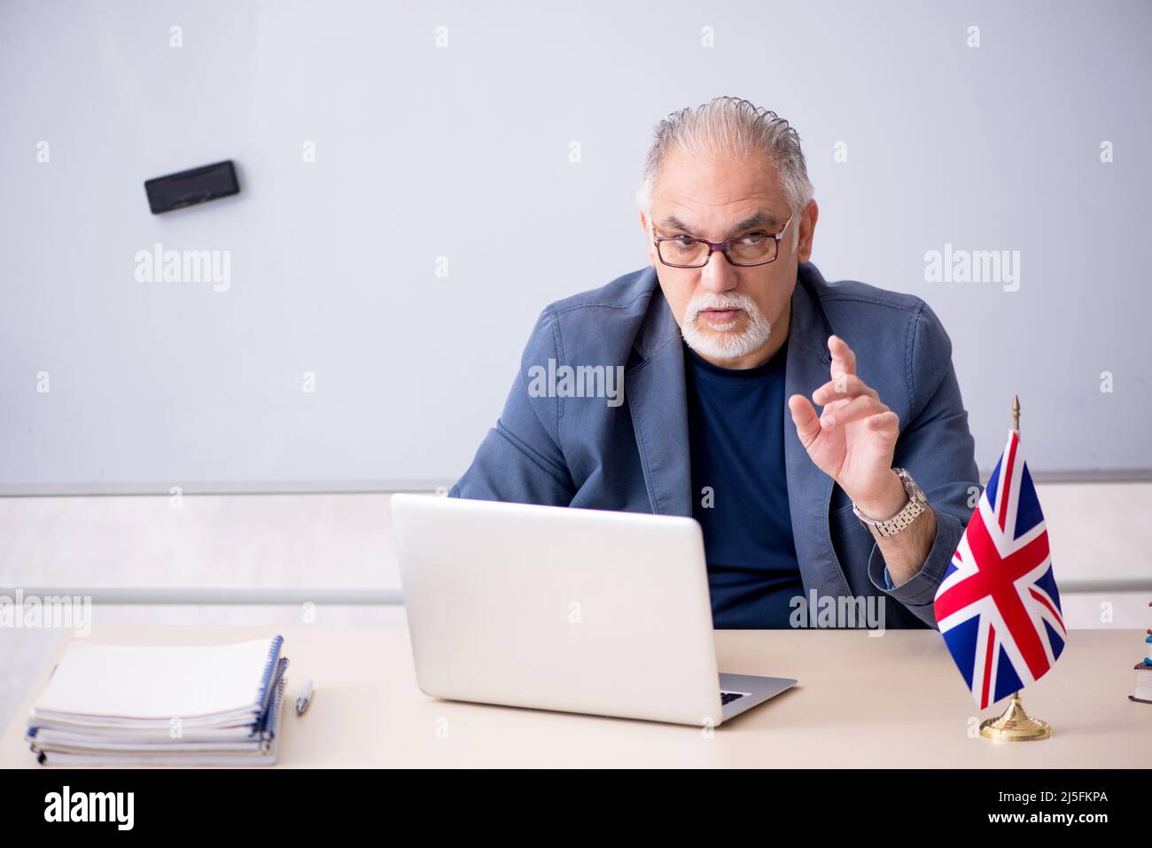 Old english language teacher in the classroom Stock Photo - Alamy