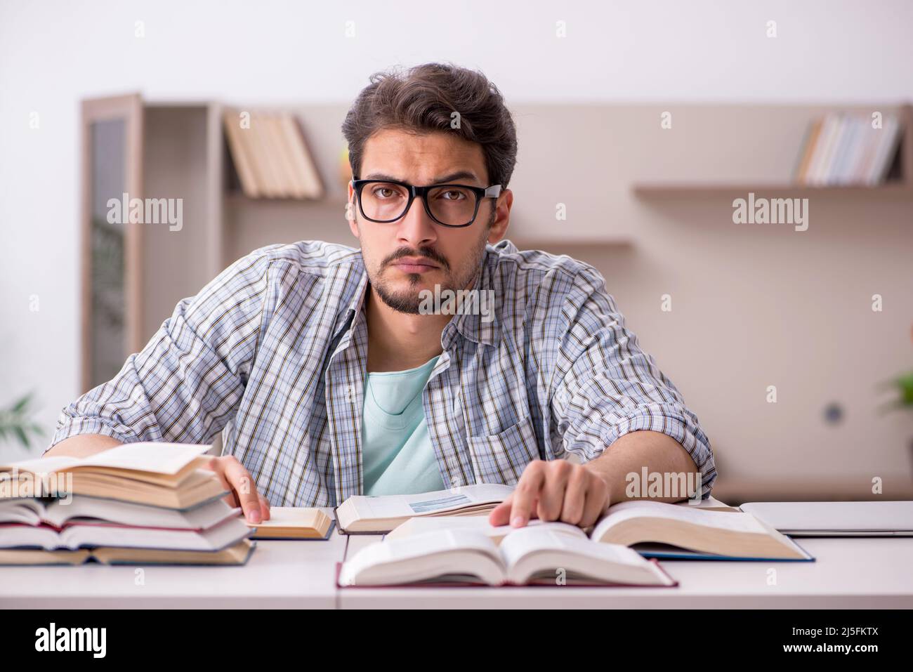 Young student preparing for exams at home Stock Photo - Alamy