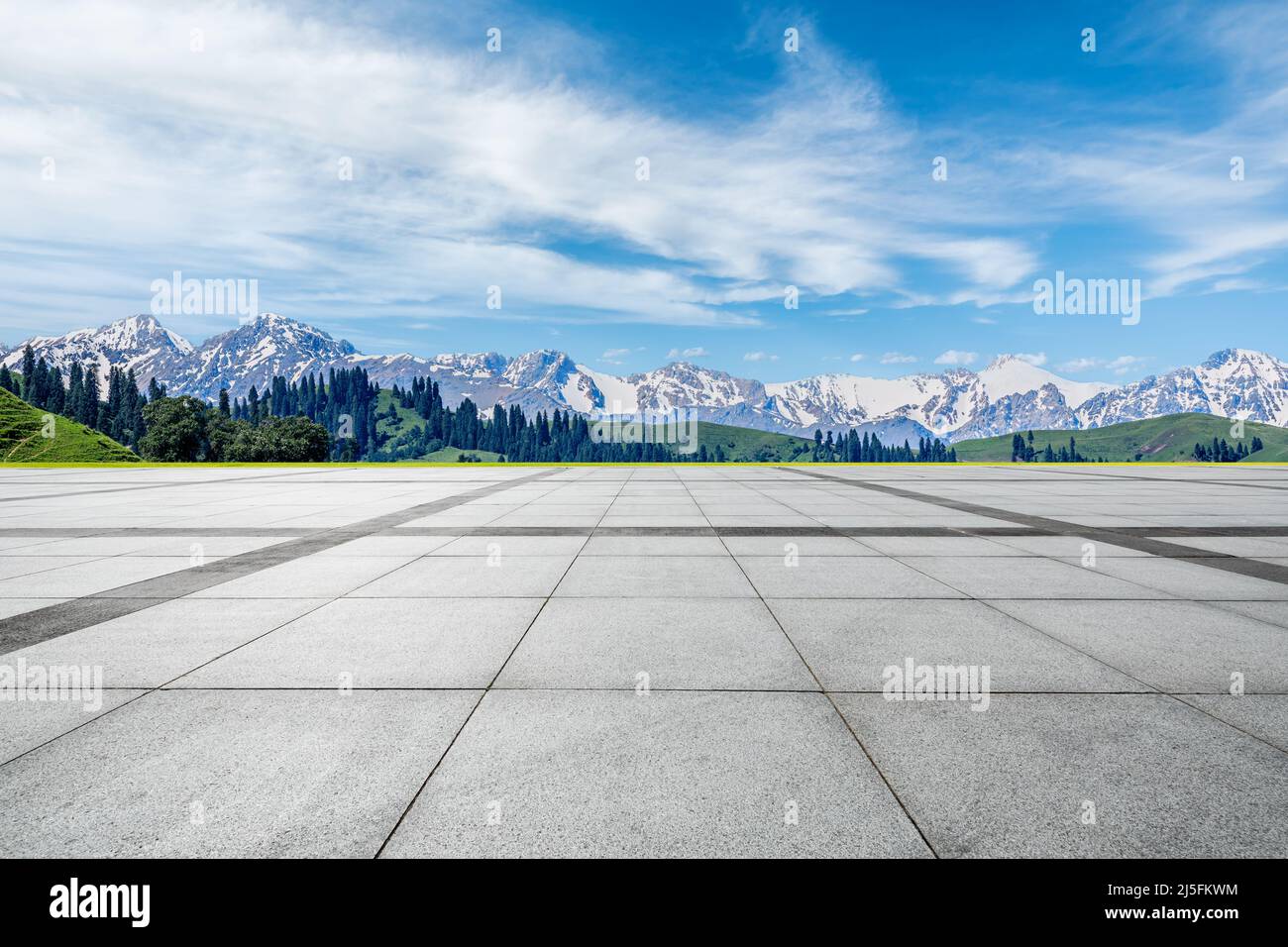 Empty square floor and snow mountain under blue sky. Road and mountain ...