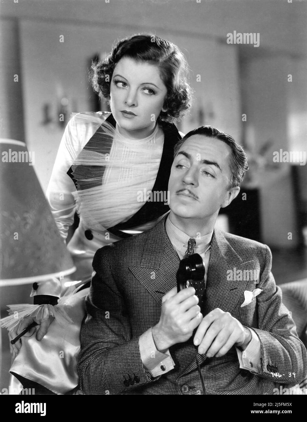 MYRNA LOY as Nora Charles and WILLIAM POWELL as Nick Charles in THE THIN MAN 11934 director W.S ...