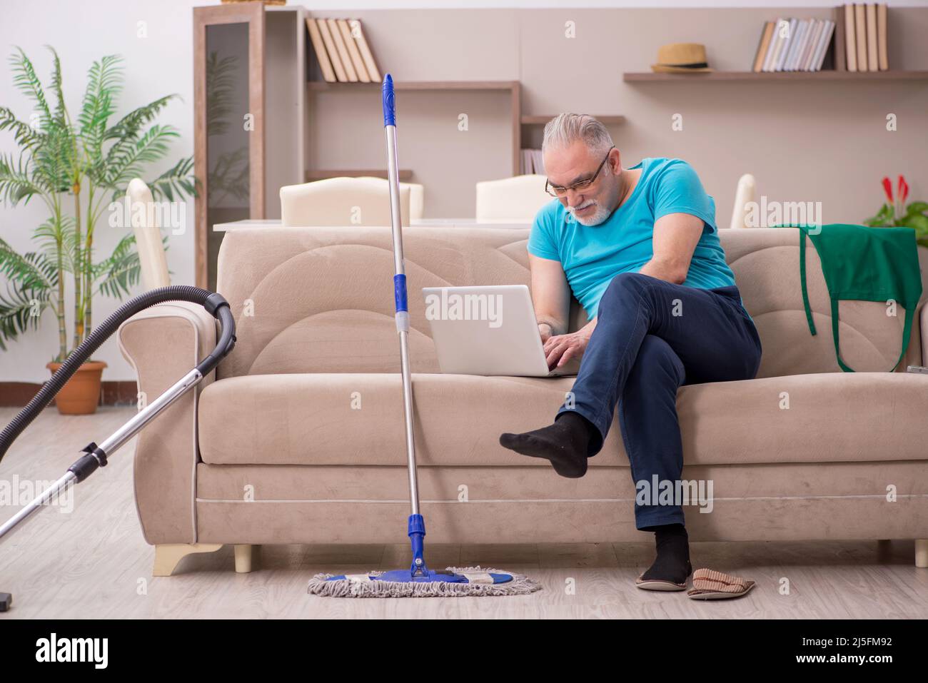 Aged man cleaning the house Stock Photo - Alamy