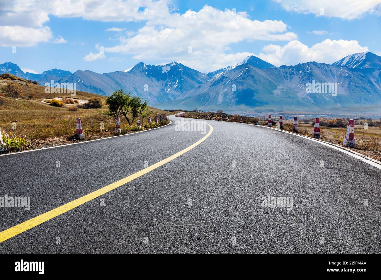 Curved asphalt road and mountain nature scenery under blue sky Stock ...