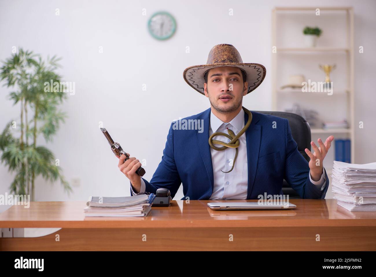 Young cowboy employee working at workplace Stock Photo - Alamy