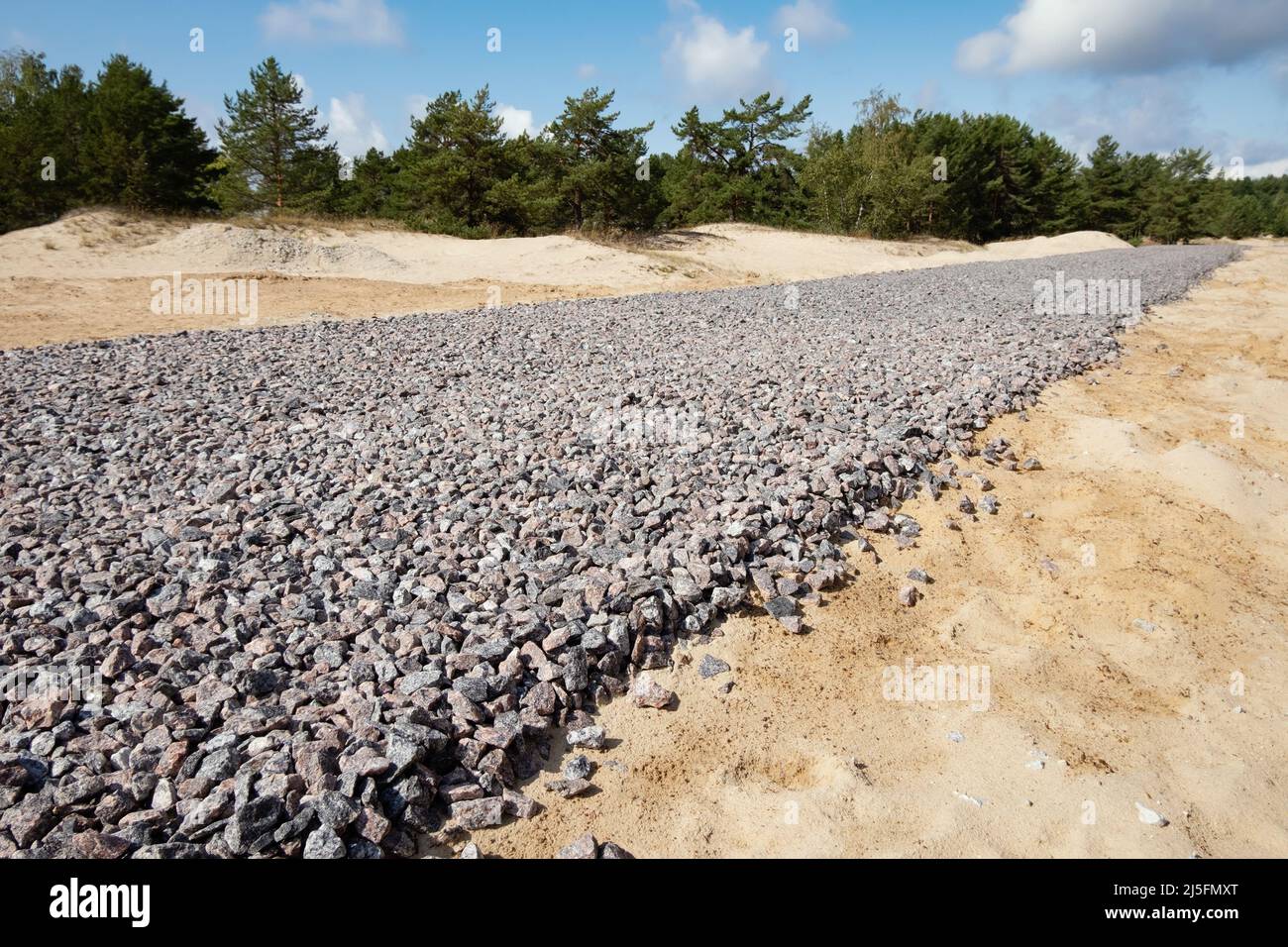 Gravel road under construction among sand and forest Stock Photo - Alamy