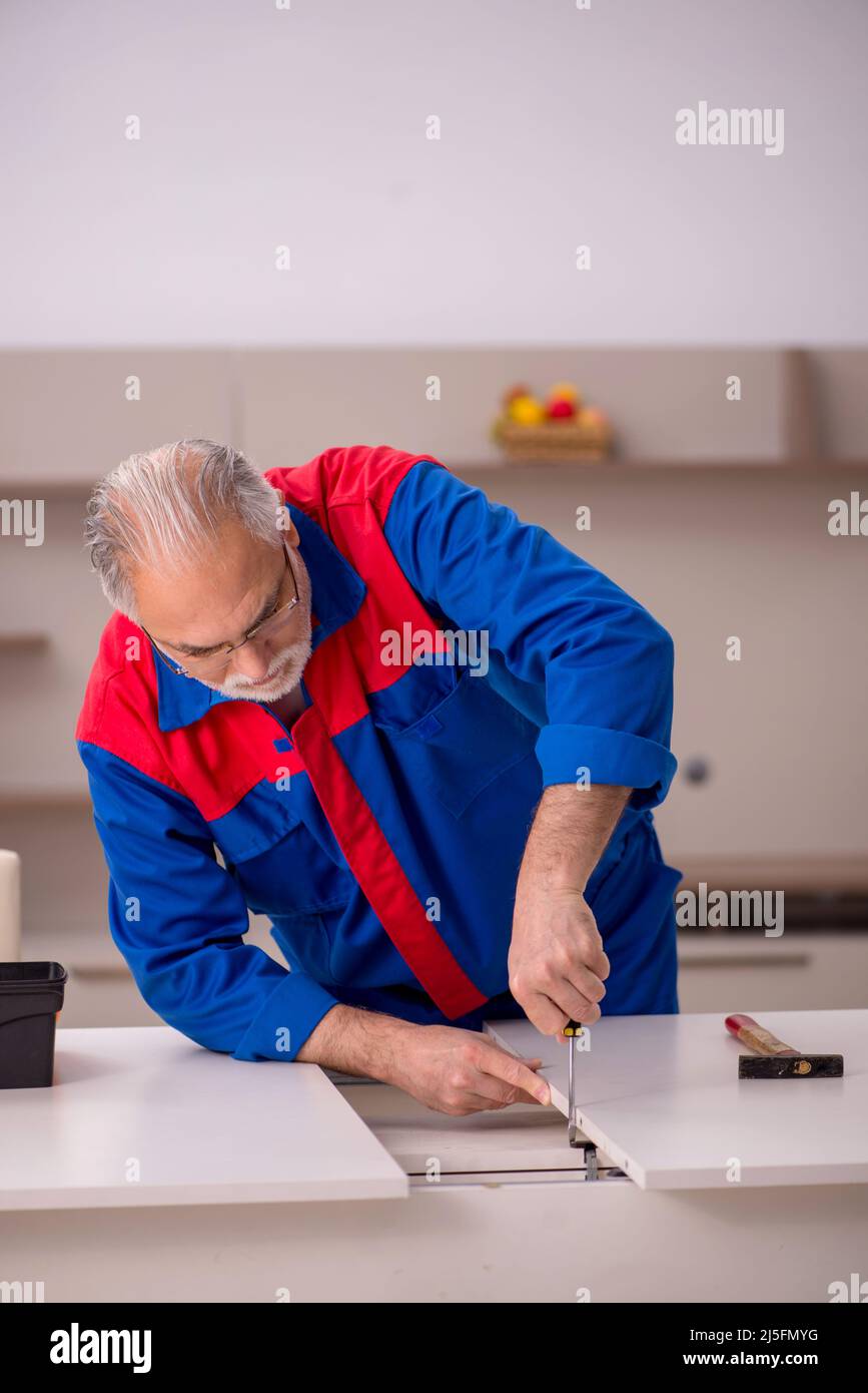 Old carpenter working at home Stock Photo - Alamy