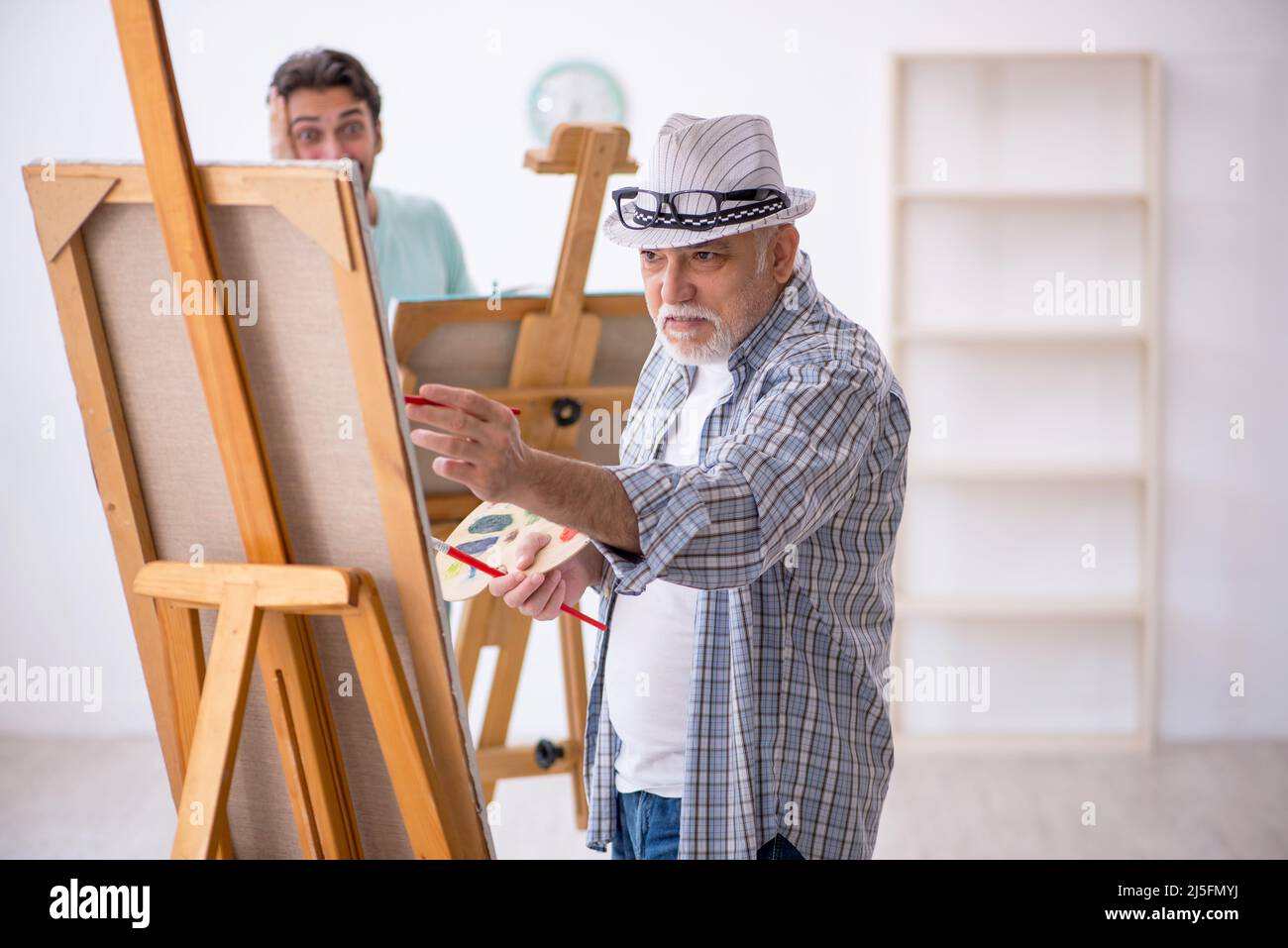 Two painters enjoying painting at home Stock Photo - Alamy