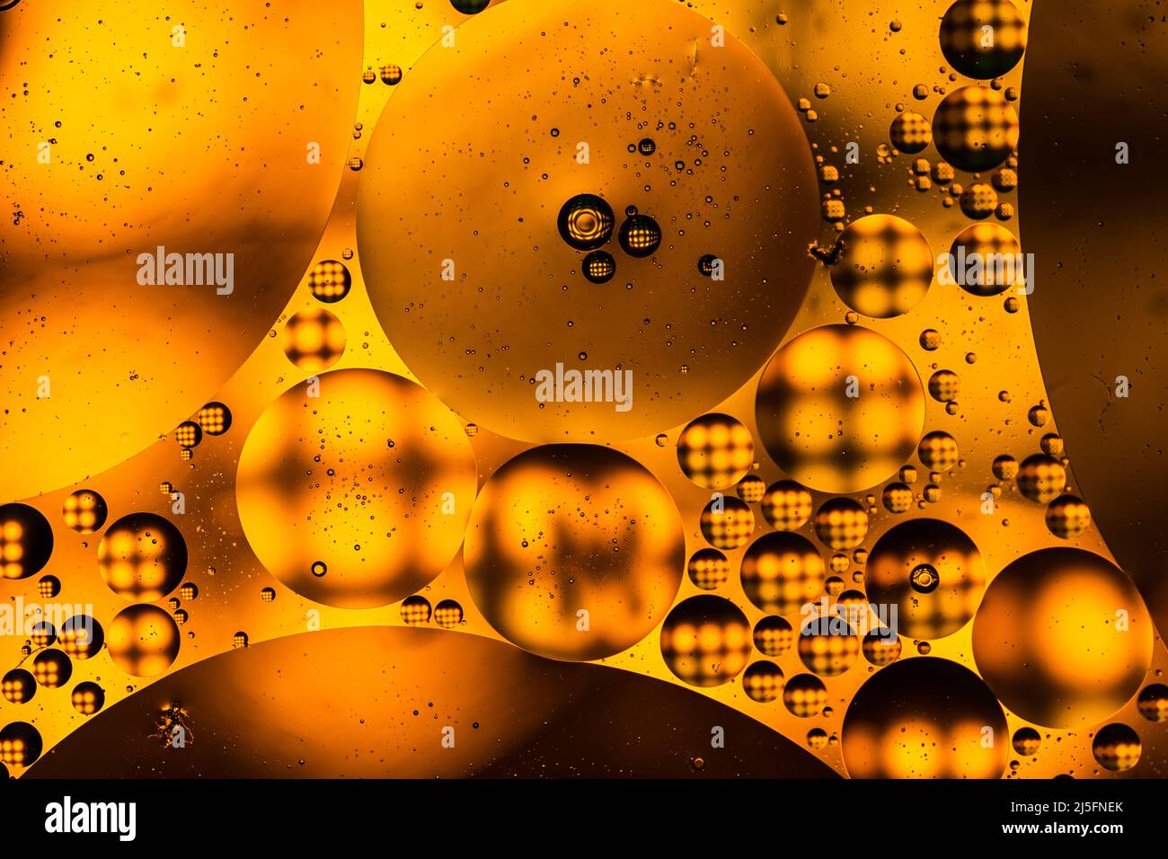 Abstract colorful backdrop with oil drops and waves on water surface ...