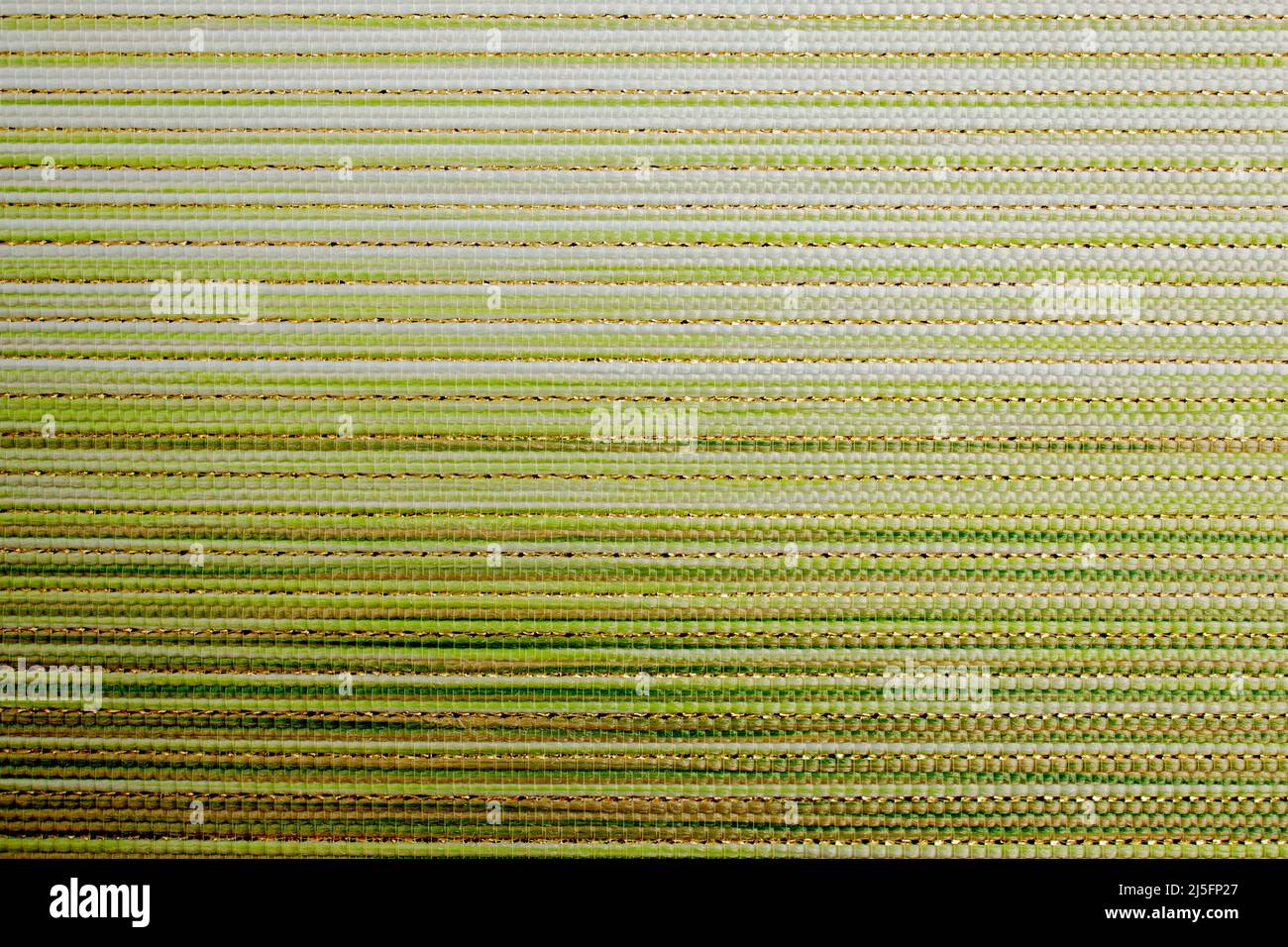 Background from dense dense fabric. Color transition from green to ...