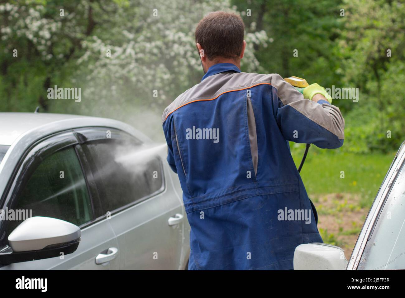 The car is washed at the car wash. Washing the car from dirt. High ...