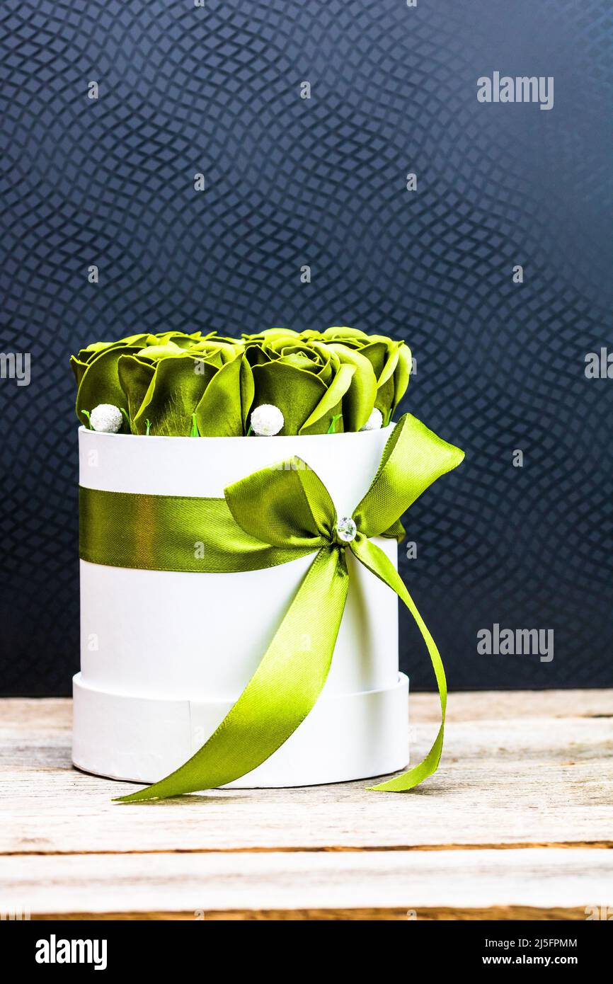 Green roses in a round luxury present box. Bouquet of flowers in a ...