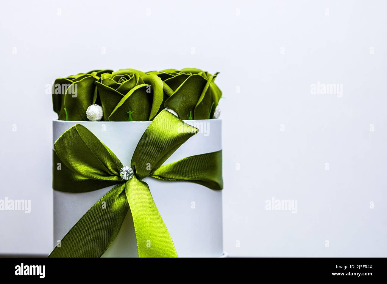 Green roses in a round luxury present box. Bouquet of flowers in a ...