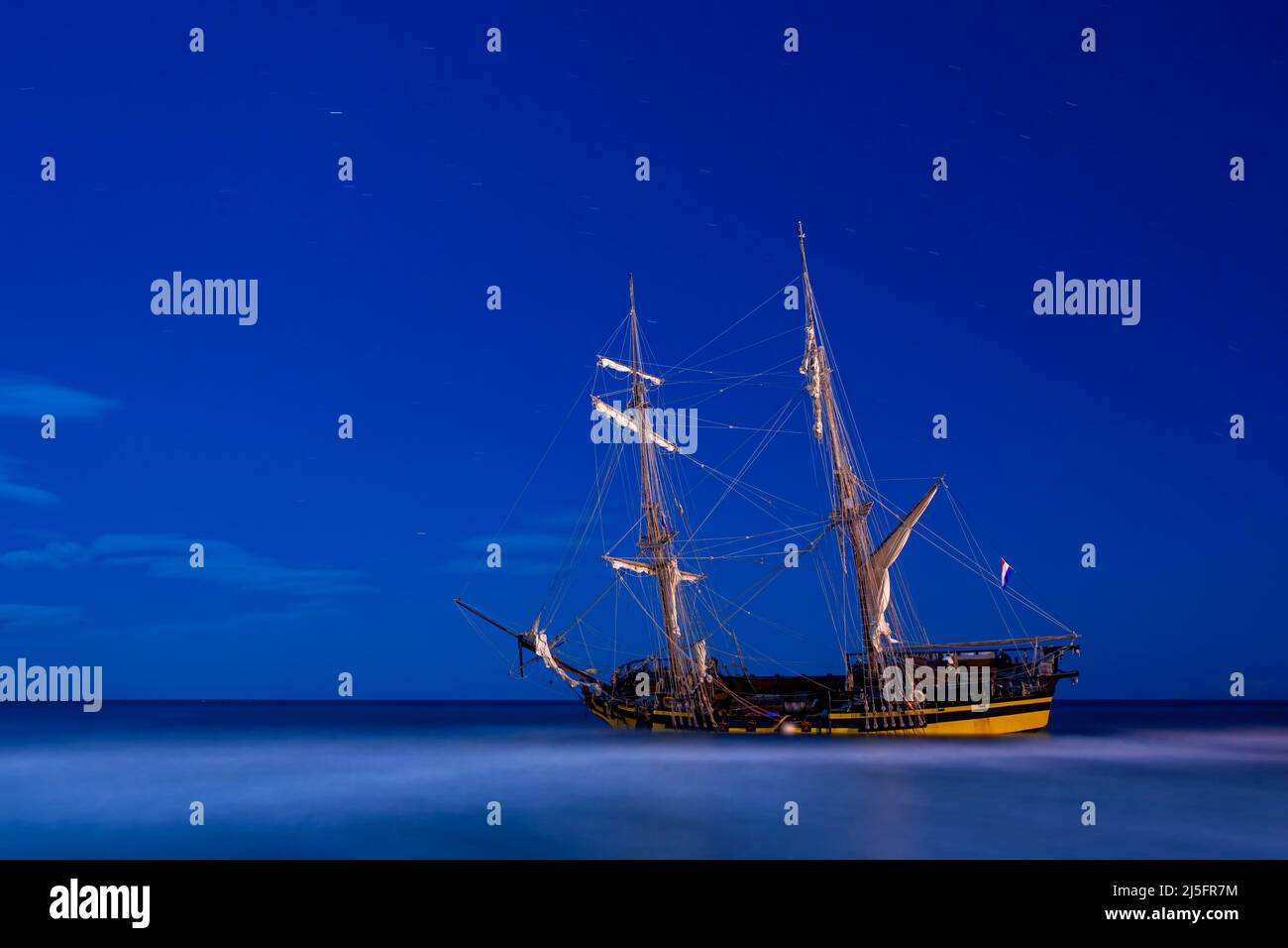 Beautiful night by a vintage brigantine sailing ship Stock Photo - Alamy