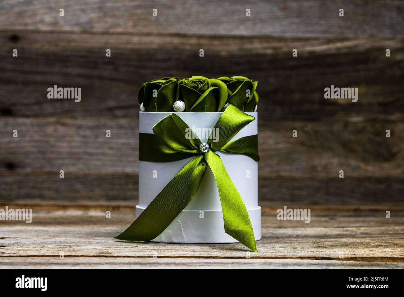 Green roses in a round luxury present box. Bouquet of flowers in a ...