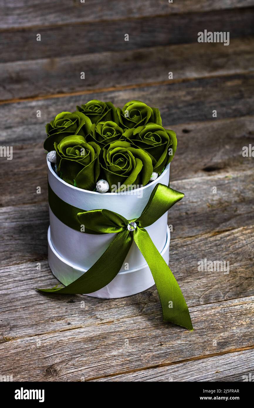 Green roses in a round luxury present box. Bouquet of flowers in a ...