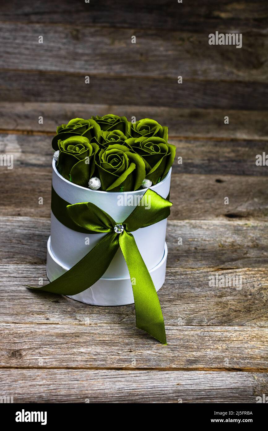Green roses in a round luxury present box. Bouquet of flowers in a ...
