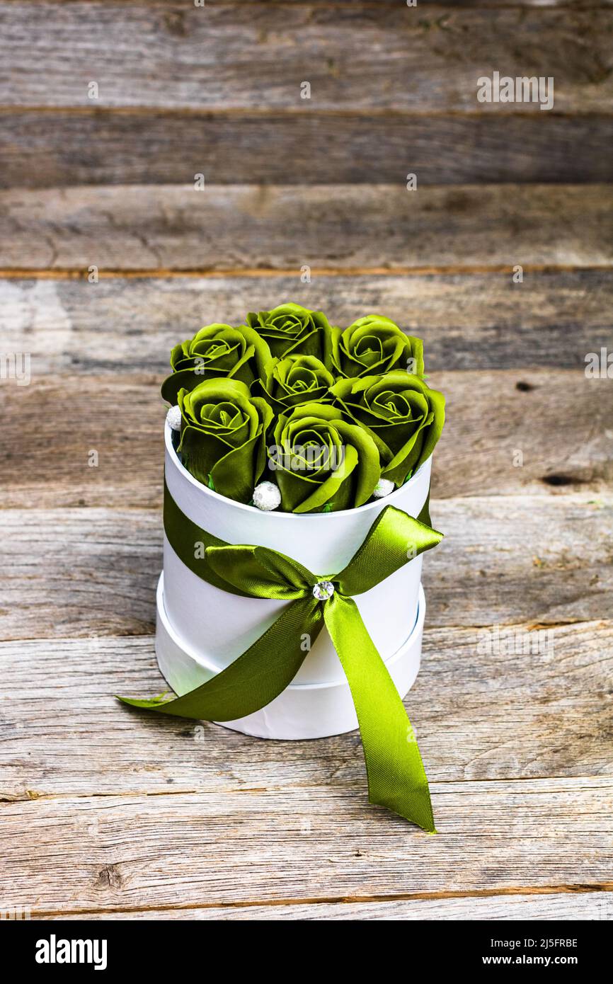 Green roses in a round luxury present box. Bouquet of flowers in a ...