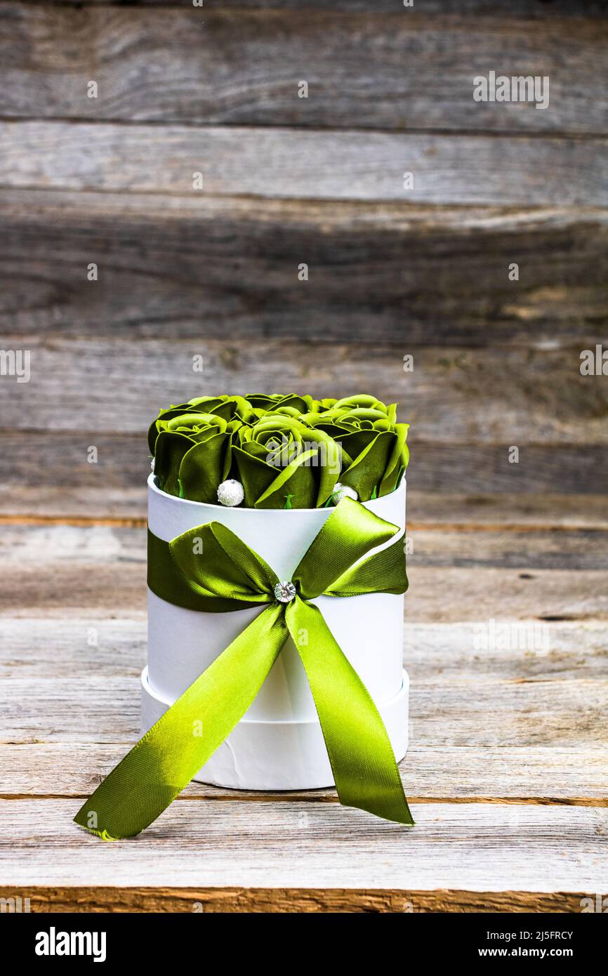 Green roses in a round luxury present box. Bouquet of flowers in a ...