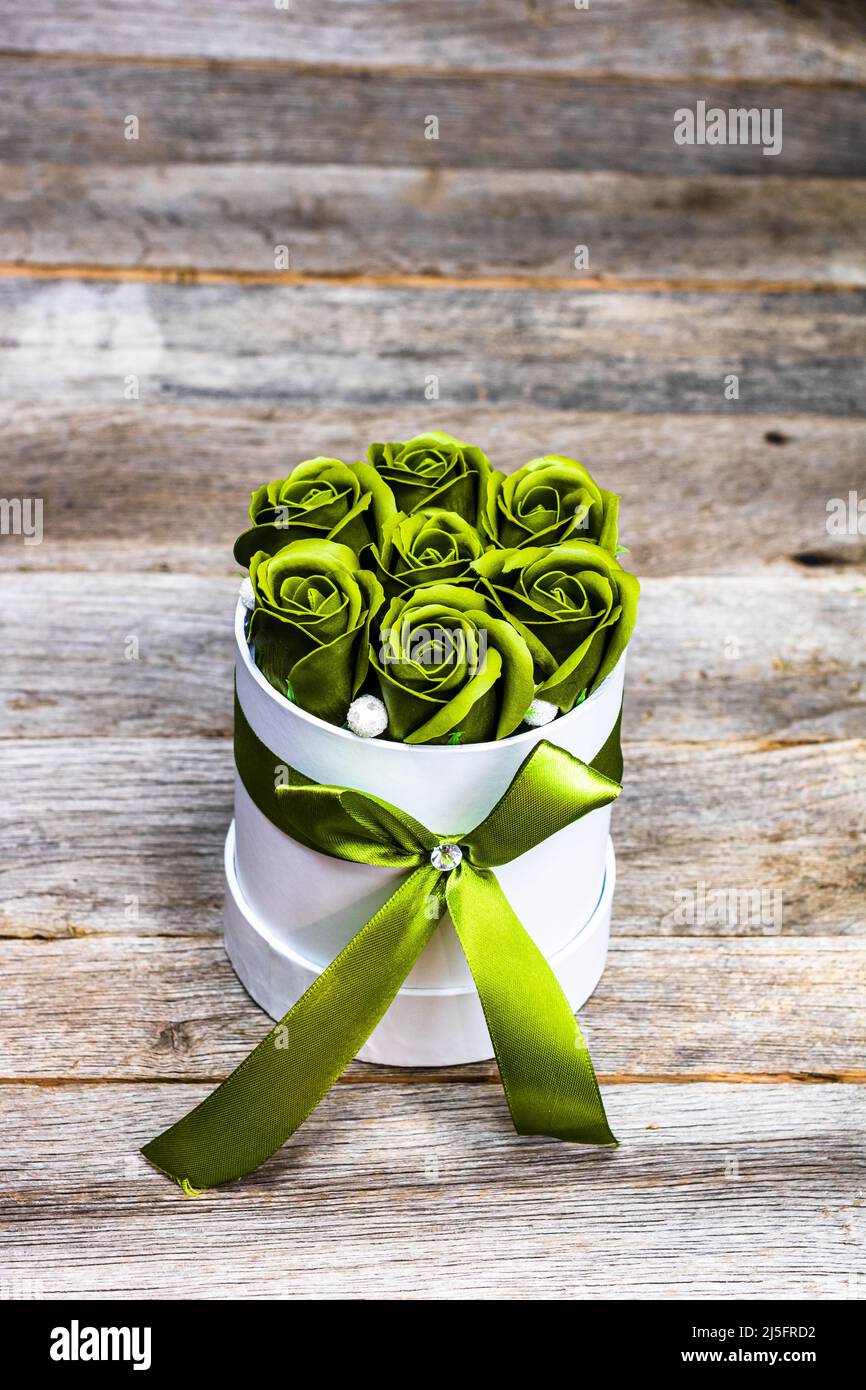 Green roses in a round luxury present box. Bouquet of flowers in a ...