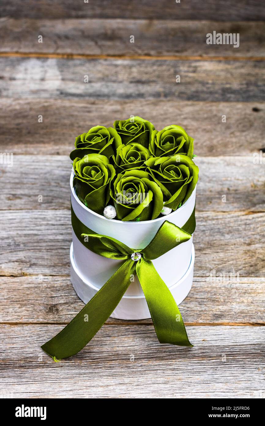 Green roses in a round luxury present box. Bouquet of flowers in a ...