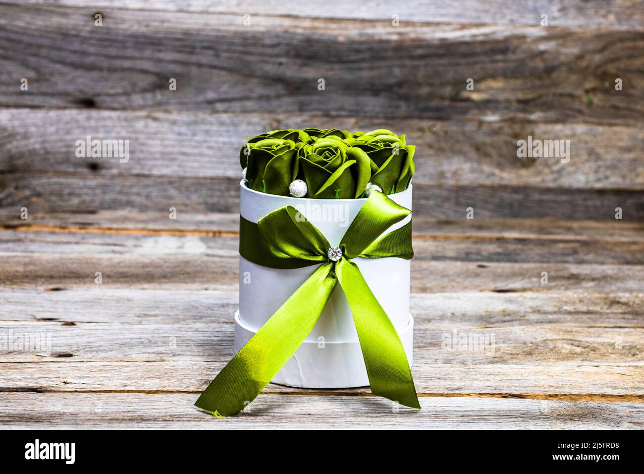 Green roses in a round luxury present box. Bouquet of flowers in a ...