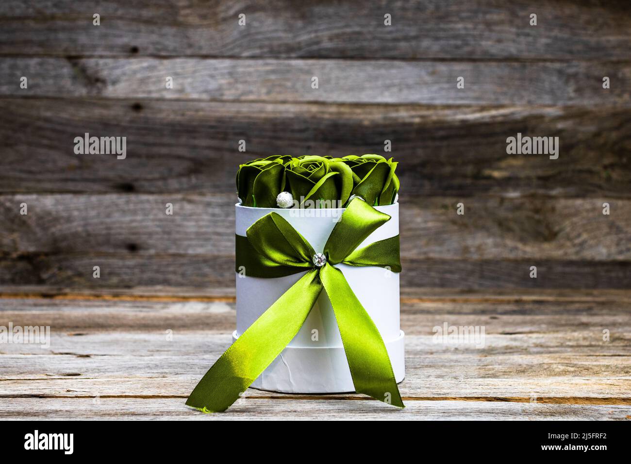 Green roses in a round luxury present box. Bouquet of flowers in a ...