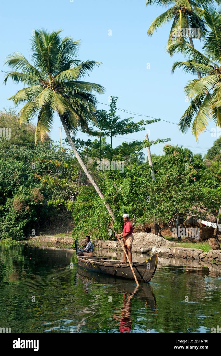 Boatman navigating on the Kerala backwaters near Kollam state Kerala ...