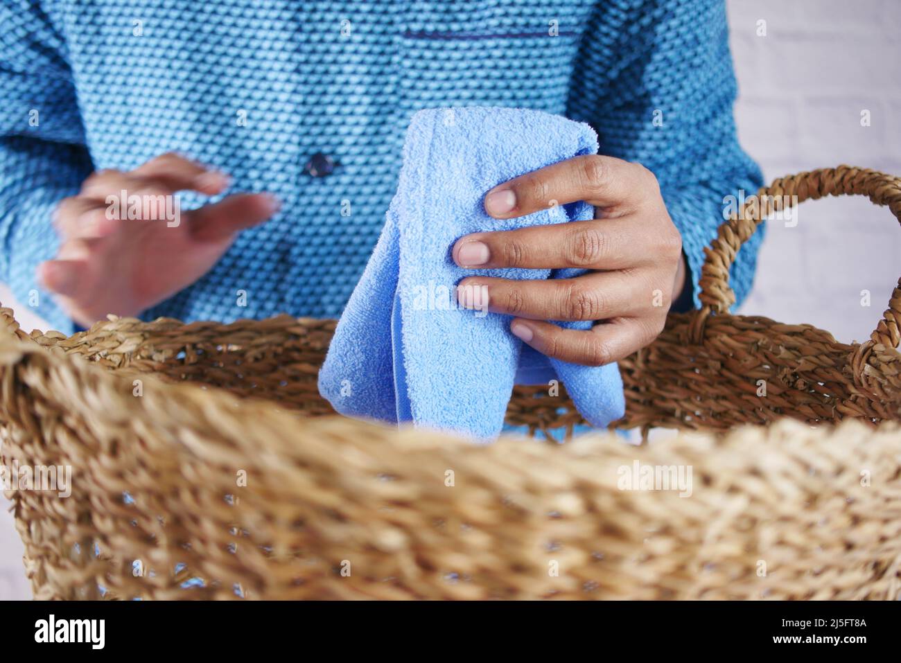 men putting Clothes in basket close up Stock Photo - Alamy
