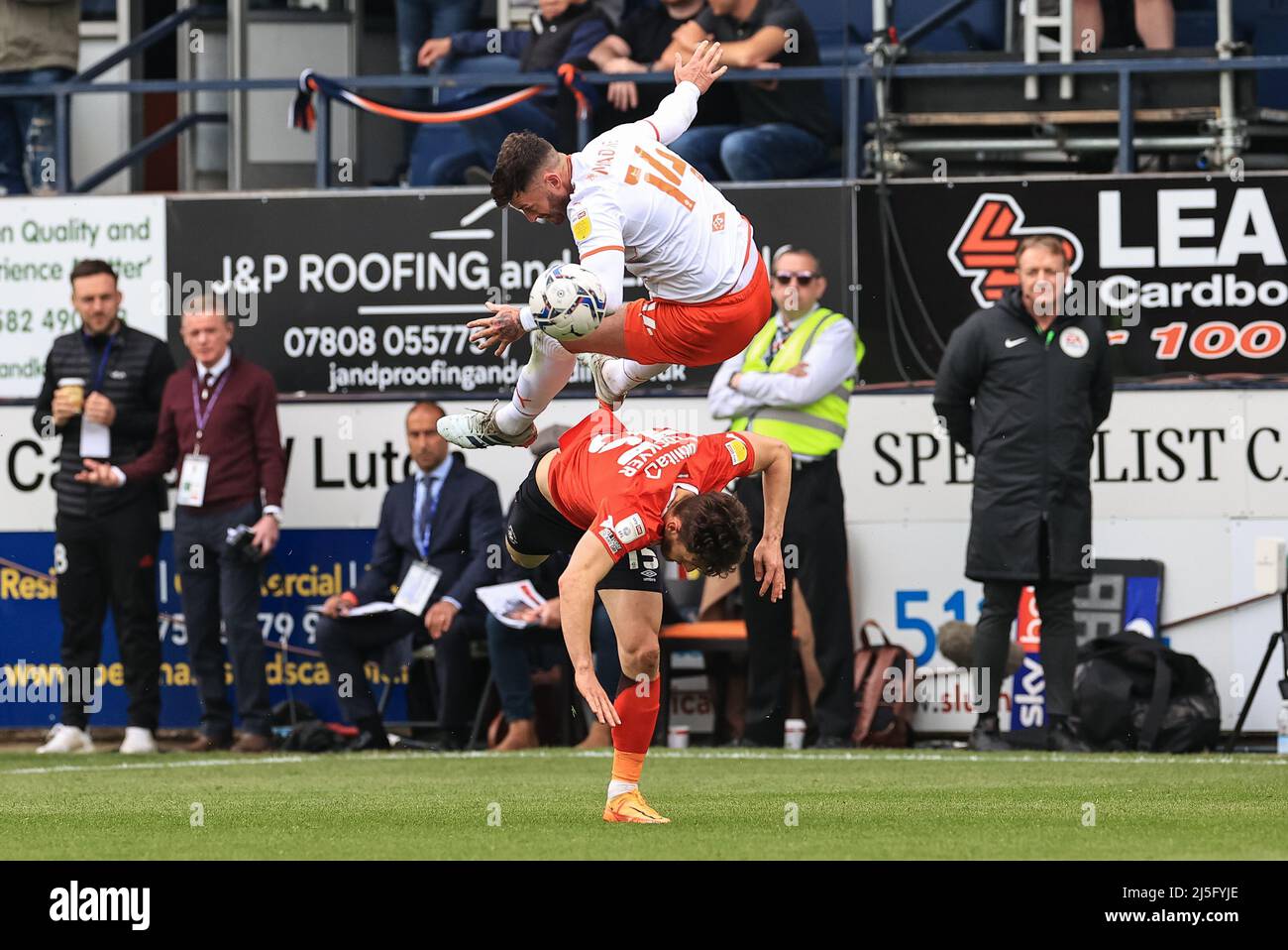 Luton, UK. 23rd Apr, 2022. Gary Madine #14 of Blackpool and Tom Lockyer ...