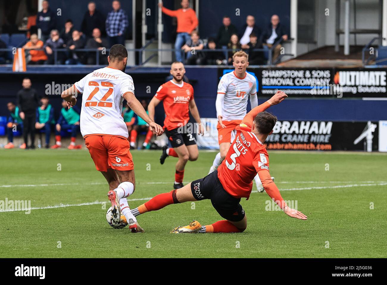 Dan Potts #3 of Luton Town brings down CJ Hamilton #22 of Blackpool ...