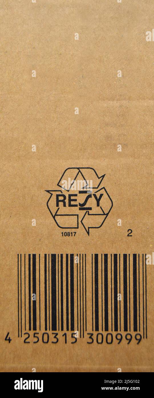 Brown and beige cardboard paper on barcodes printed recycling icon ...