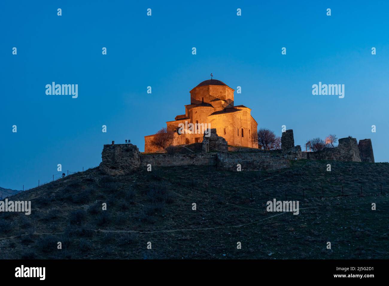Illuminated Jvari Monastery on the top of the hill at night. Mtskheta ...