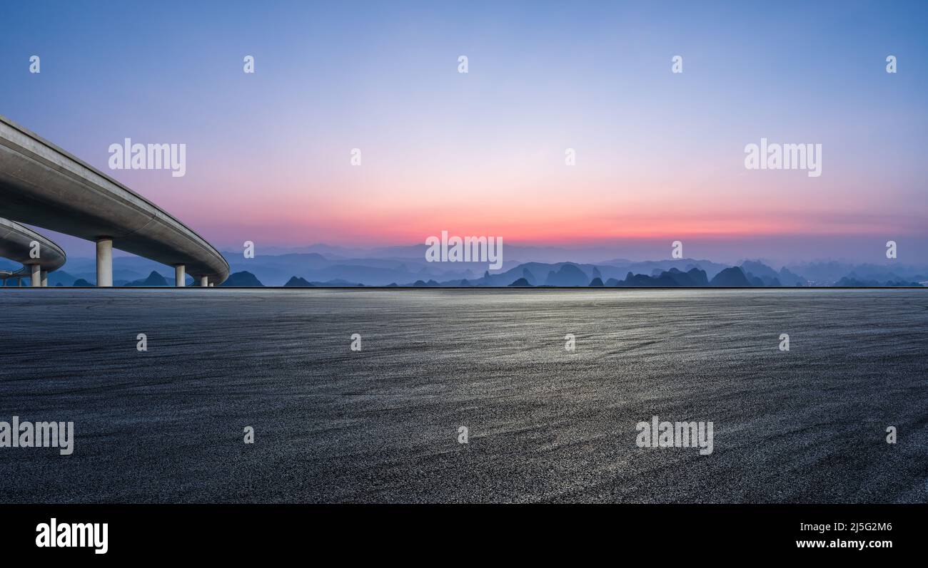 Asphalt highway and mountain natural scenery at sunset. Road and ...
