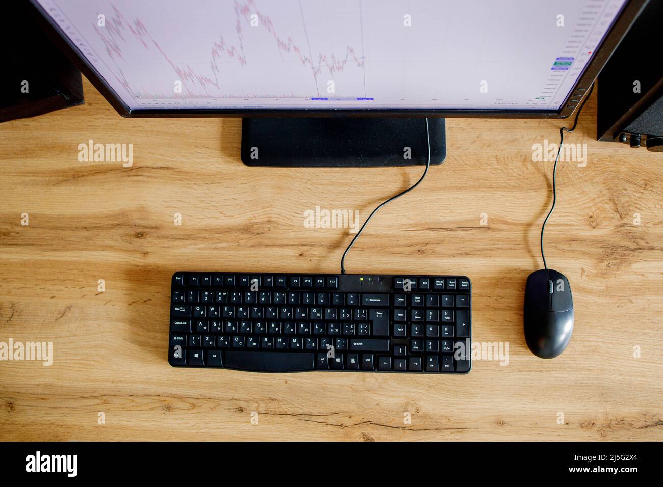 Top view of a wooden desktop with a computer monitor with graphics ...