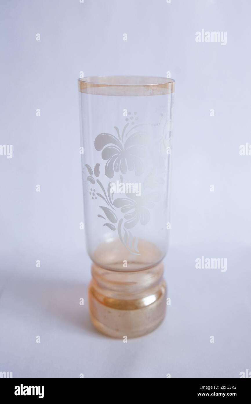 a glass transparent glass empty with a pattern on a white background ...