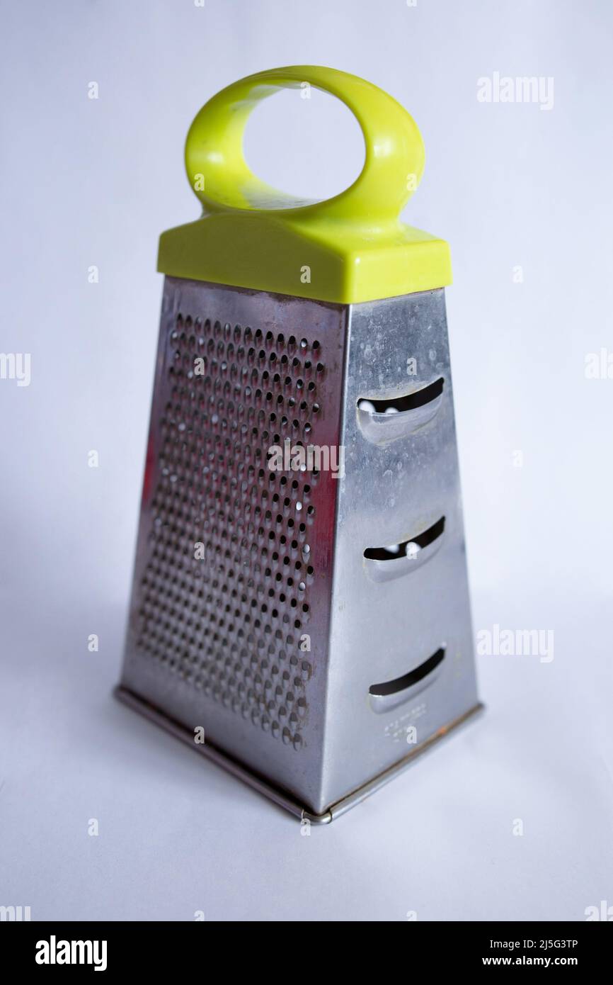 an old metal grater on a white background Stock Photo - Alamy