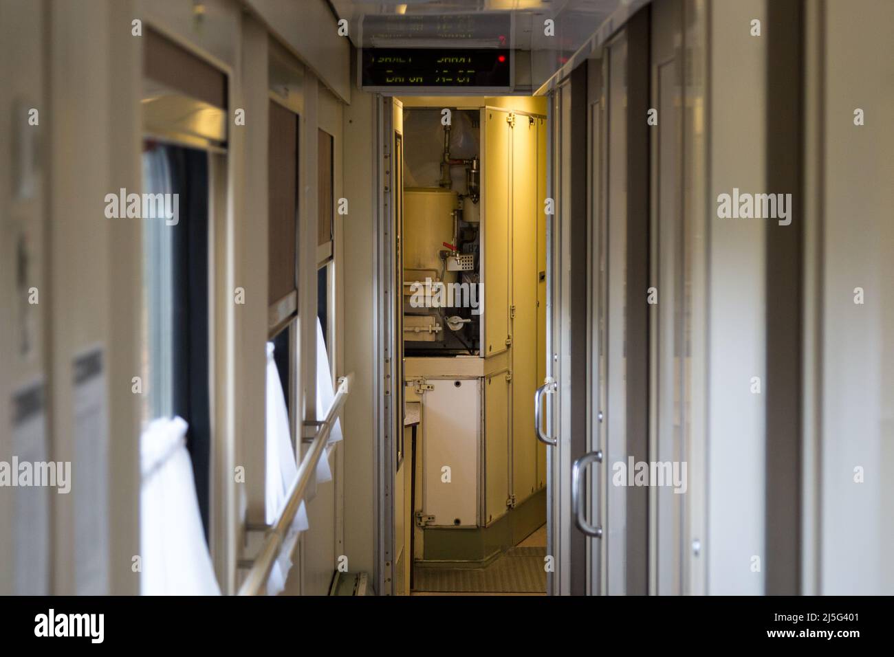 An empty corridor of a railway carriage compartment, concept of long ...