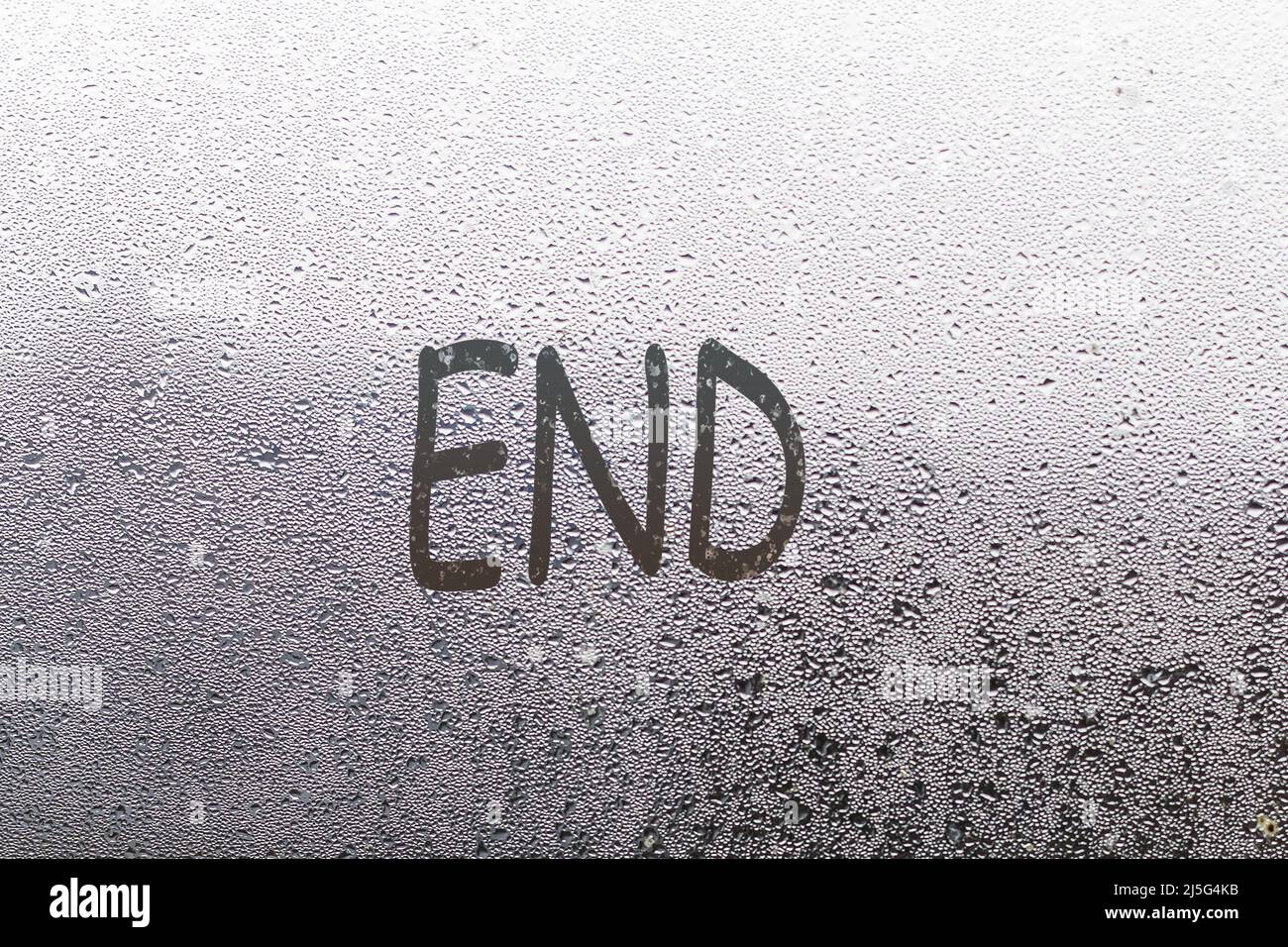 the words end handwritten on night wet window glass Stock Photo - Alamy